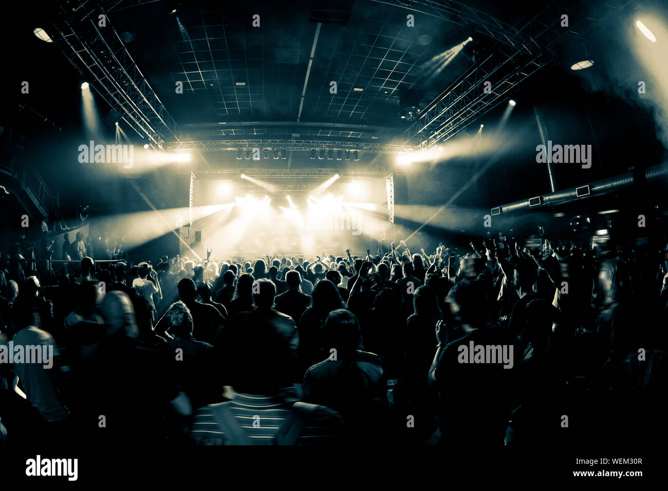Colourful concert hall with clapping people Stock Photo - Alamy
