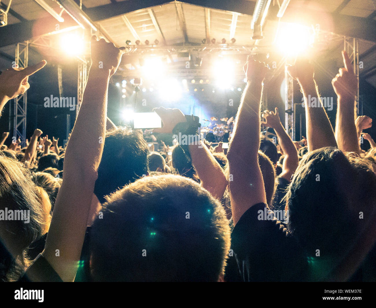 Colourful concert hall with clapping people Stock Photo - Alamy
