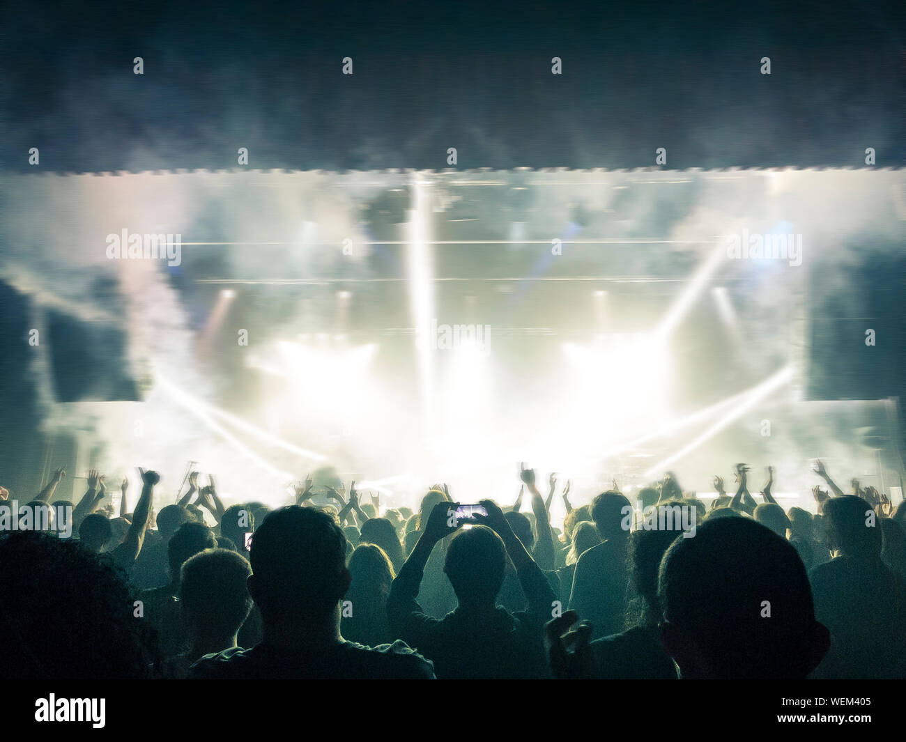 Colourful concert hall with clapping people Stock Photo - Alamy