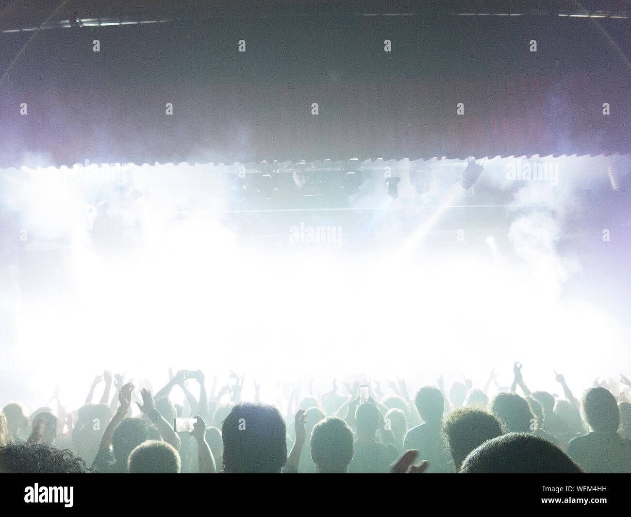 Colourful concert hall with clapping people Stock Photo - Alamy