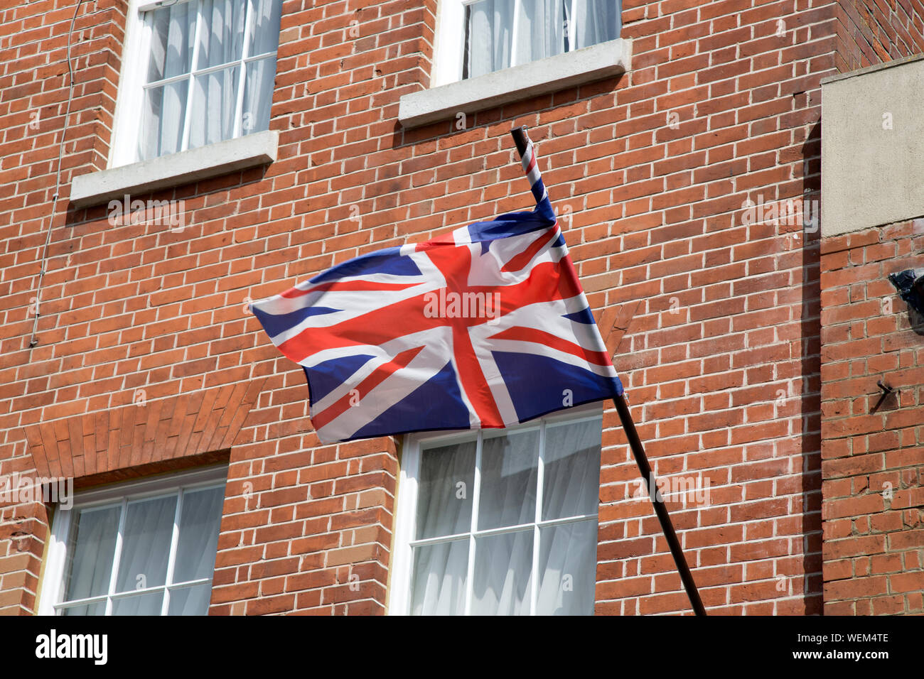Union Jack Flag against Building Facade Stock Photo - Alamy
