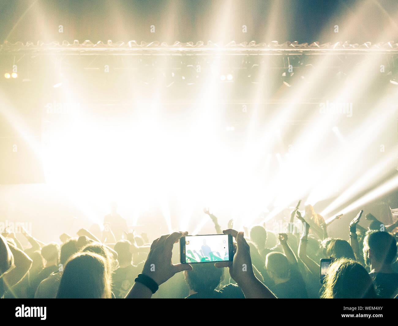 Colourful concert hall with clapping people Stock Photo - Alamy