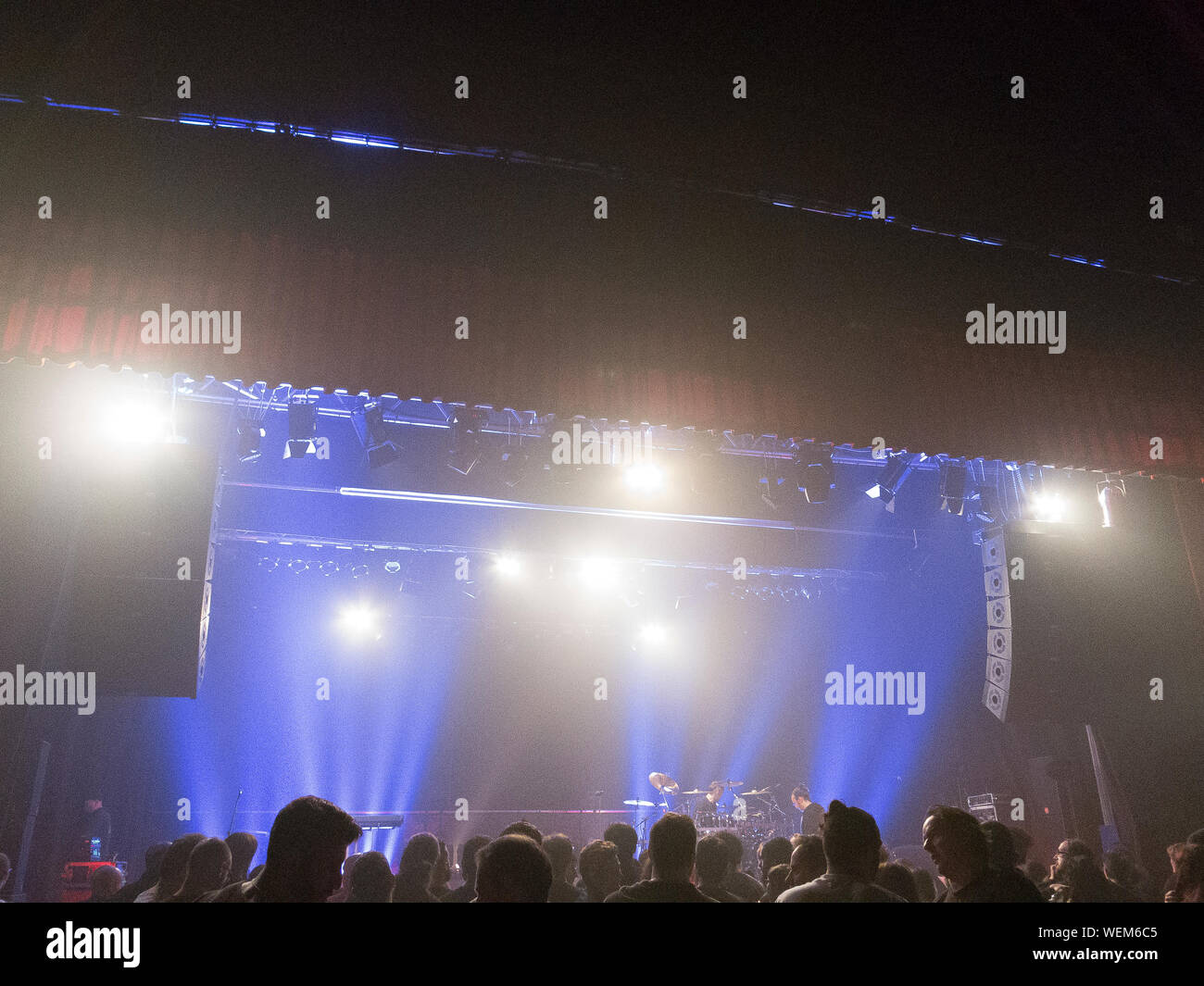 Colourful concert hall with clapping people Stock Photo - Alamy