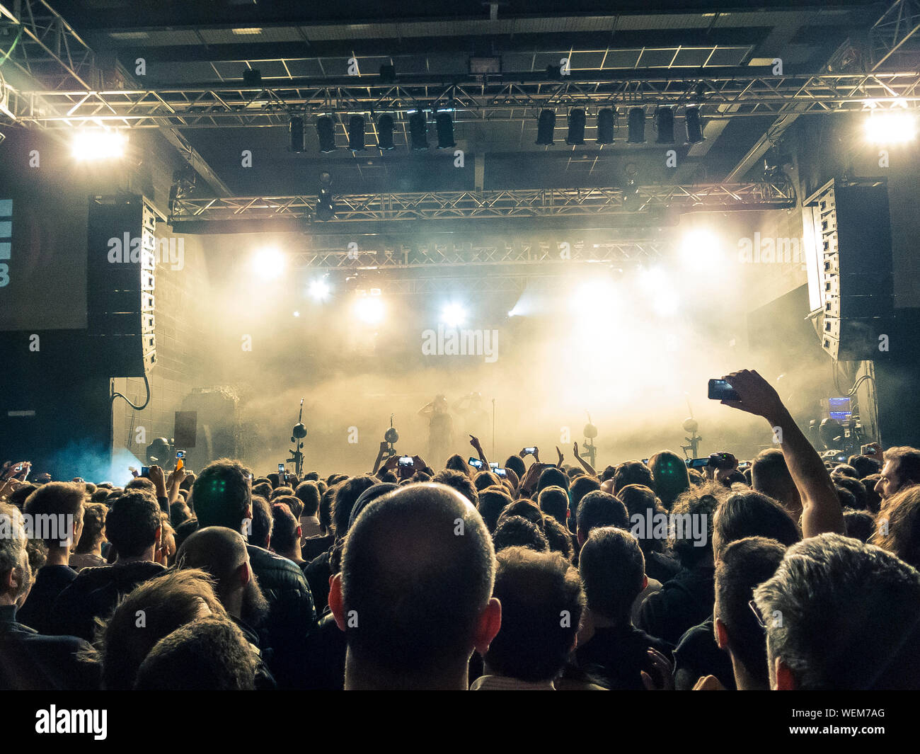 Colourful concert hall with clapping people Stock Photo - Alamy
