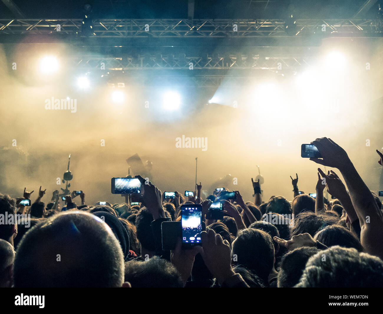 Colourful concert hall with clapping people Stock Photo - Alamy