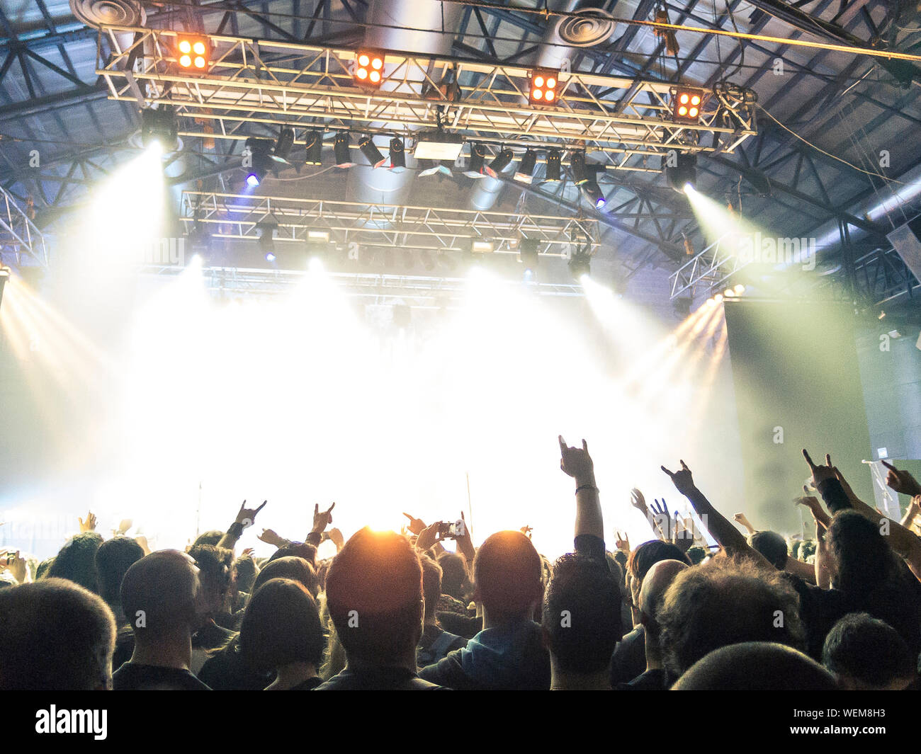 Colourful concert hall with clapping people Stock Photo - Alamy