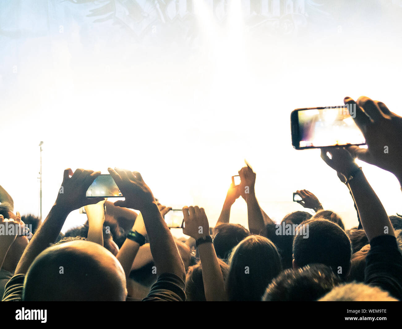 Colourful concert hall with clapping people Stock Photo - Alamy