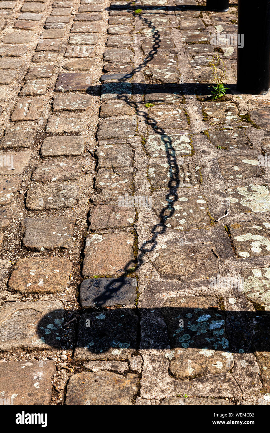 Shadow of a post and chain Stock Photo - Alamy