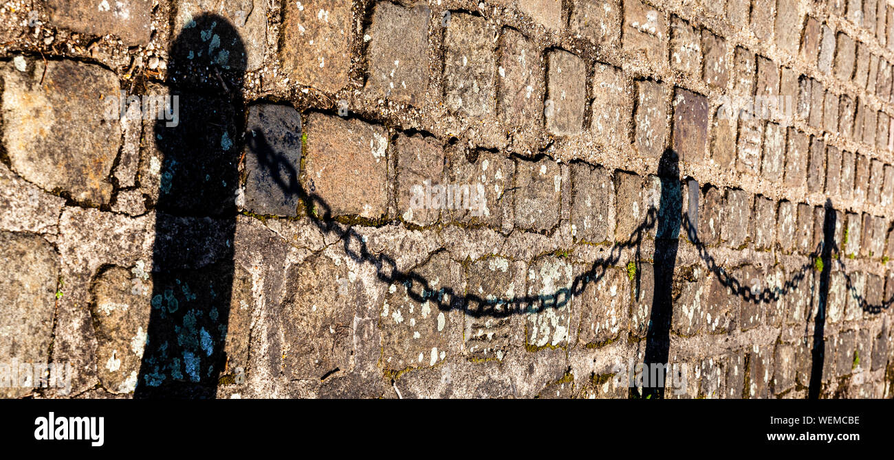 Shadow of a post and chain Stock Photo - Alamy
