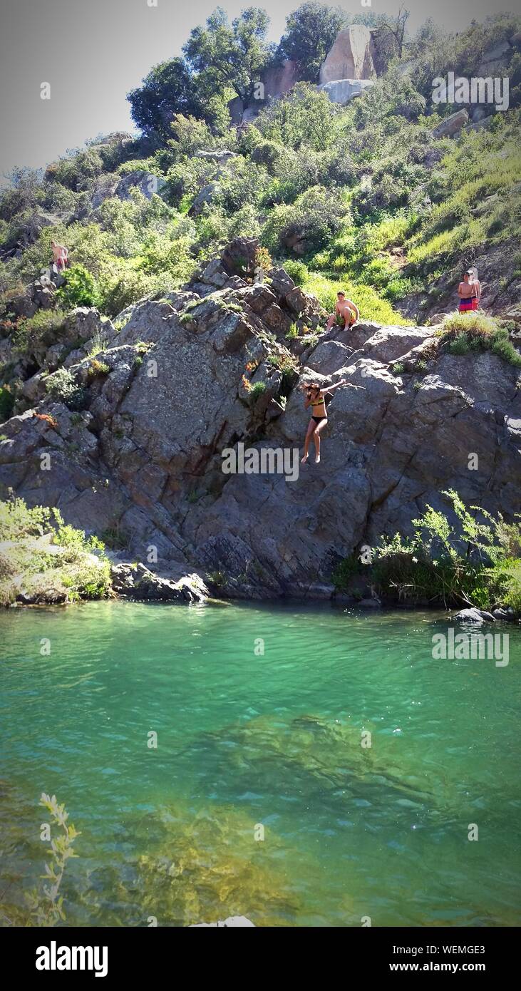 Woman jumping rock formation hi-res stock photography and images - Alamy