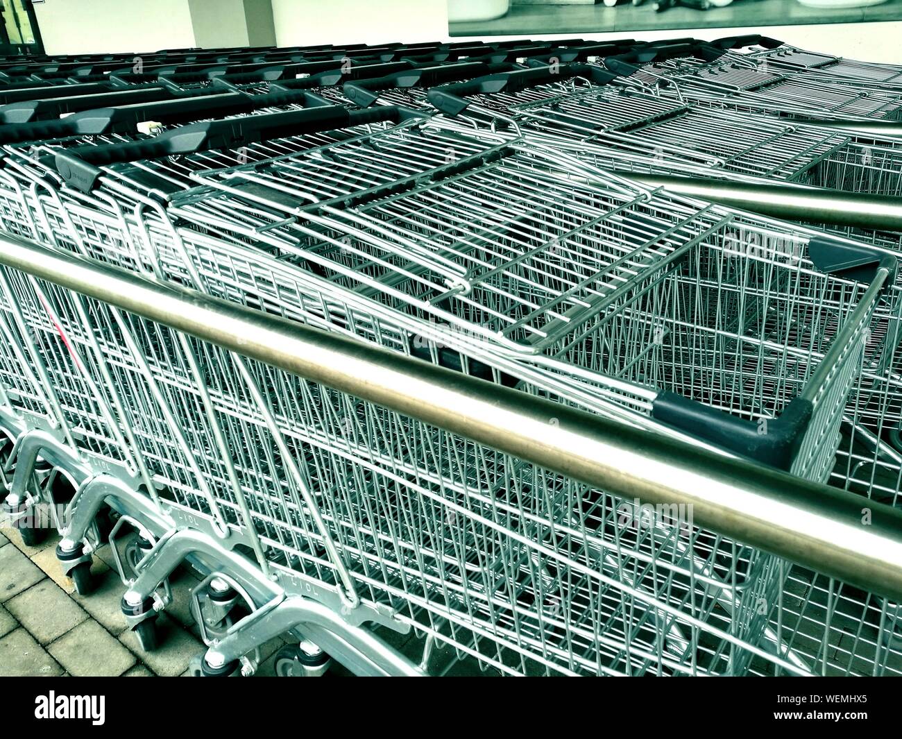Empty Shopping Carts Arranged In Supermarket Stock Photo - Alamy