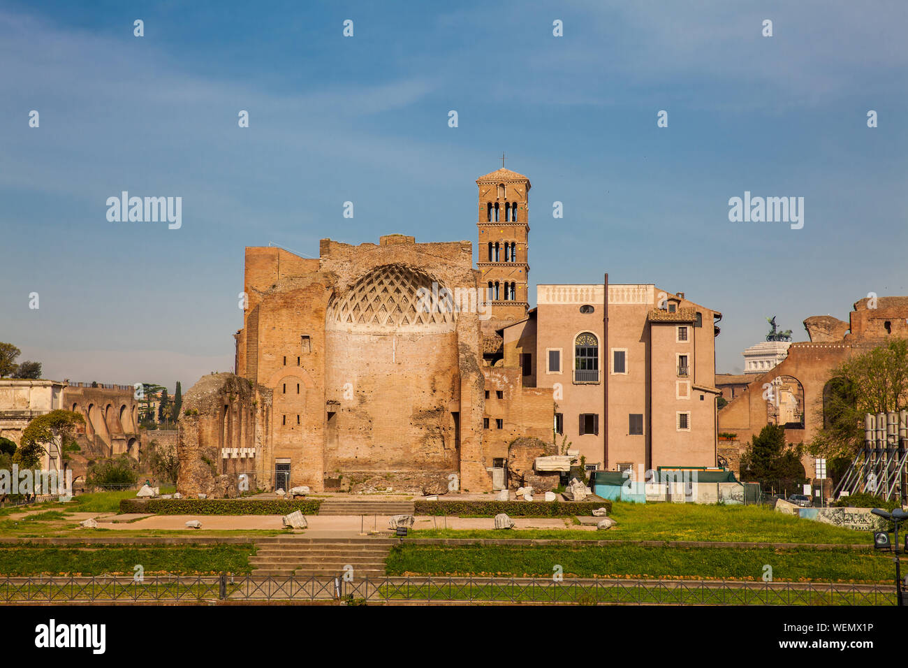 Tourists visiting the Ruins of the Temple of Venus and Roma located on ...