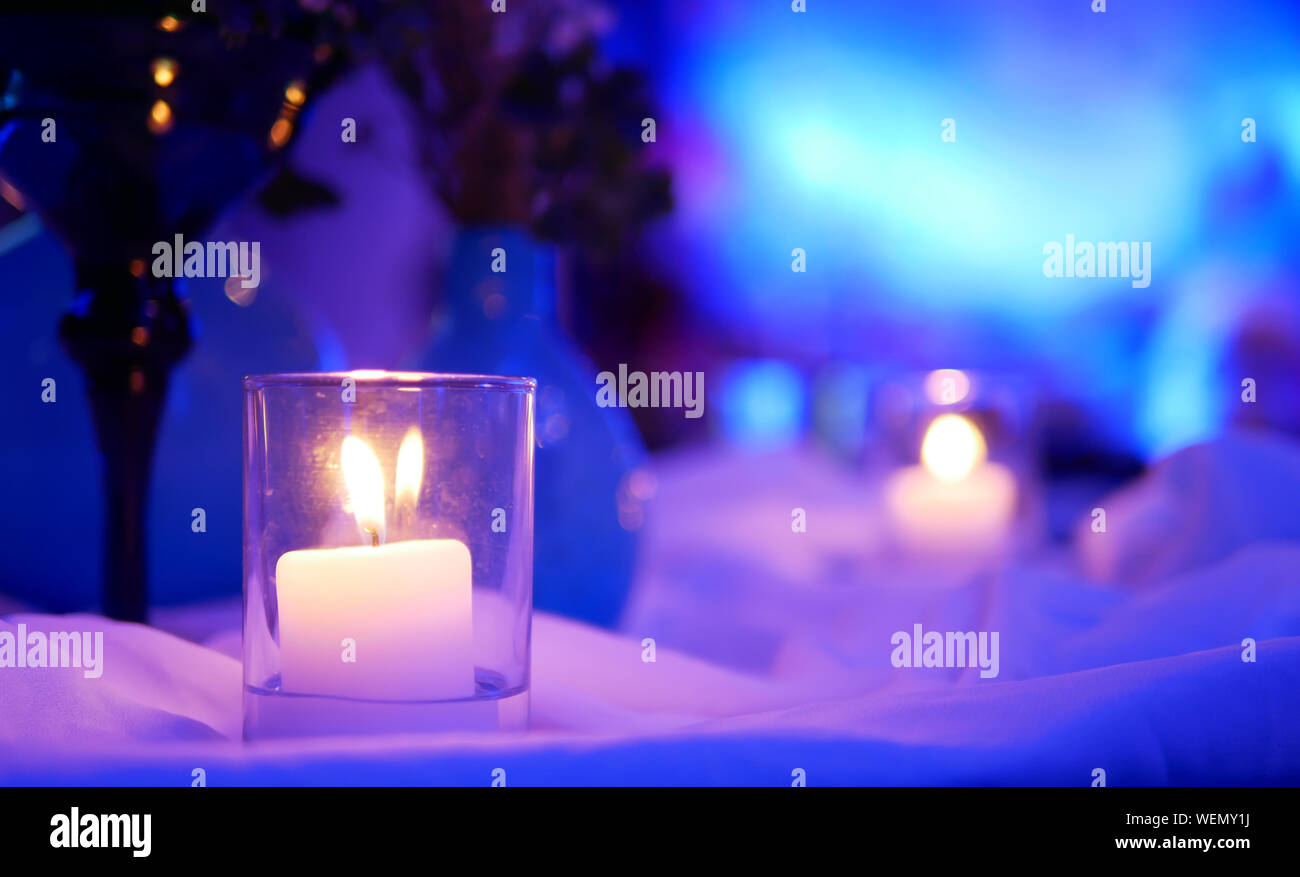 Small candlelight that have yellow spots on purple light and white ...