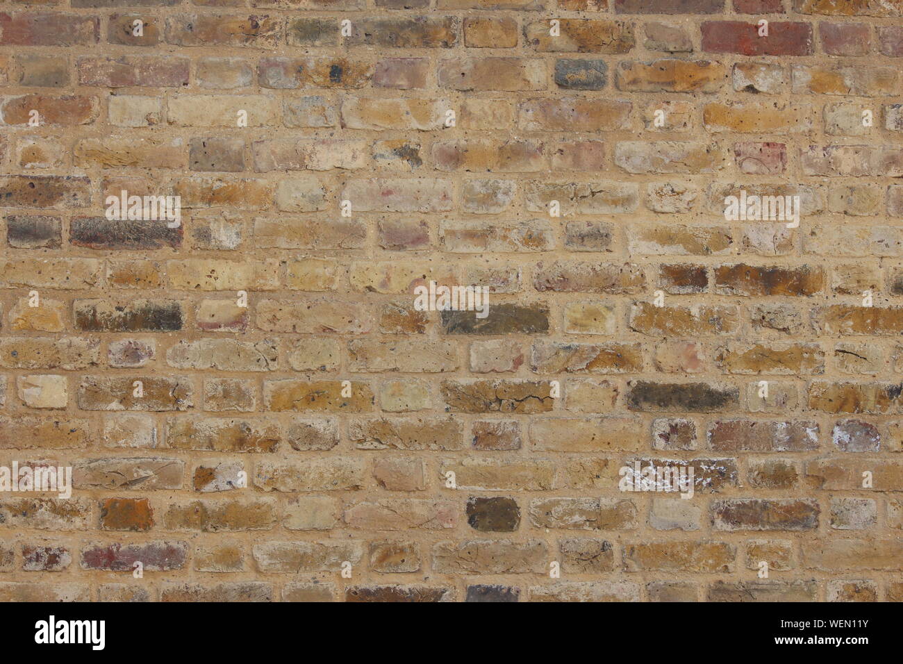 A photograph of a sand coloured brick wall. Natural stone brick ...