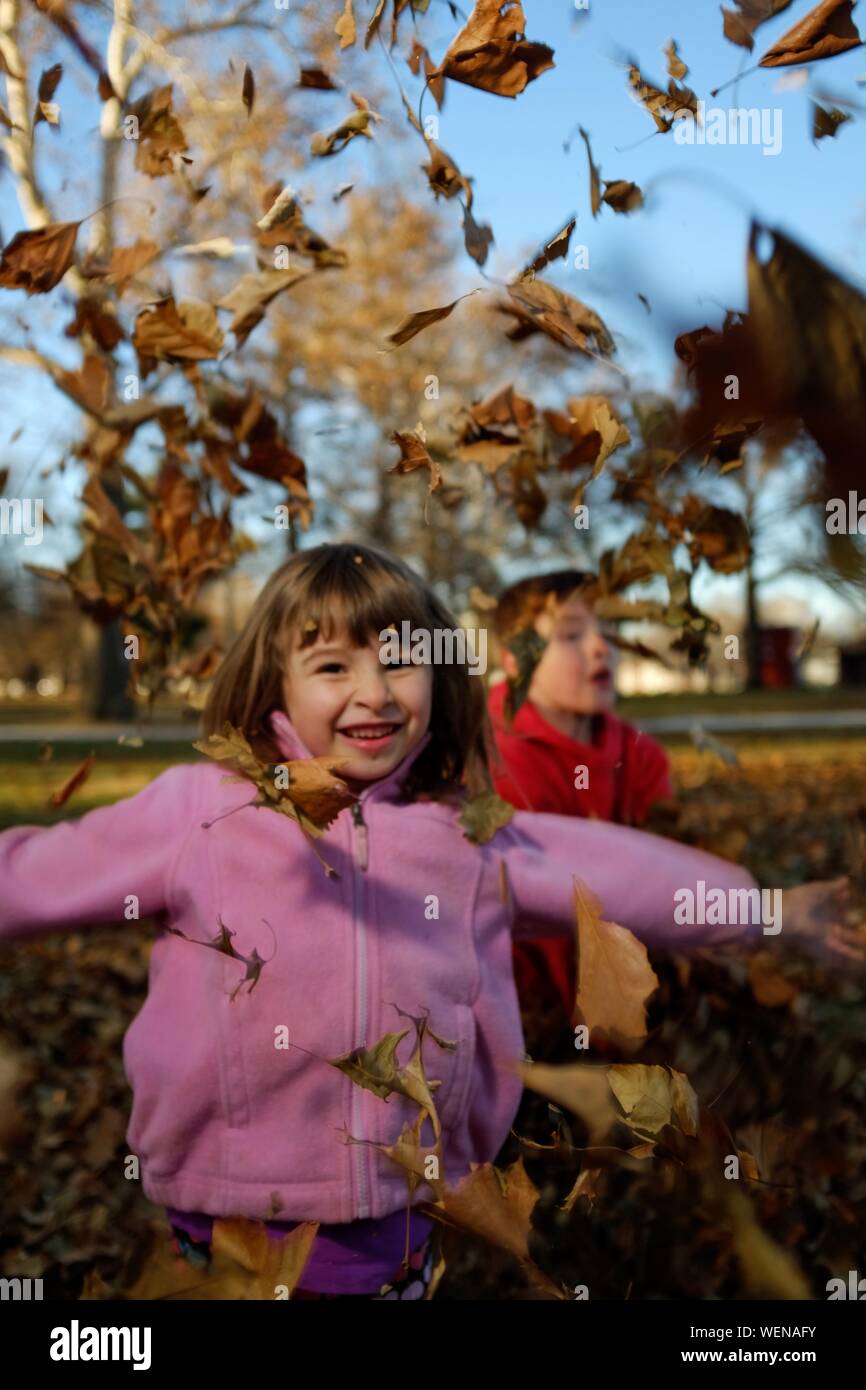Children throwing autumn leaves hi-res stock photography and images - Alamy