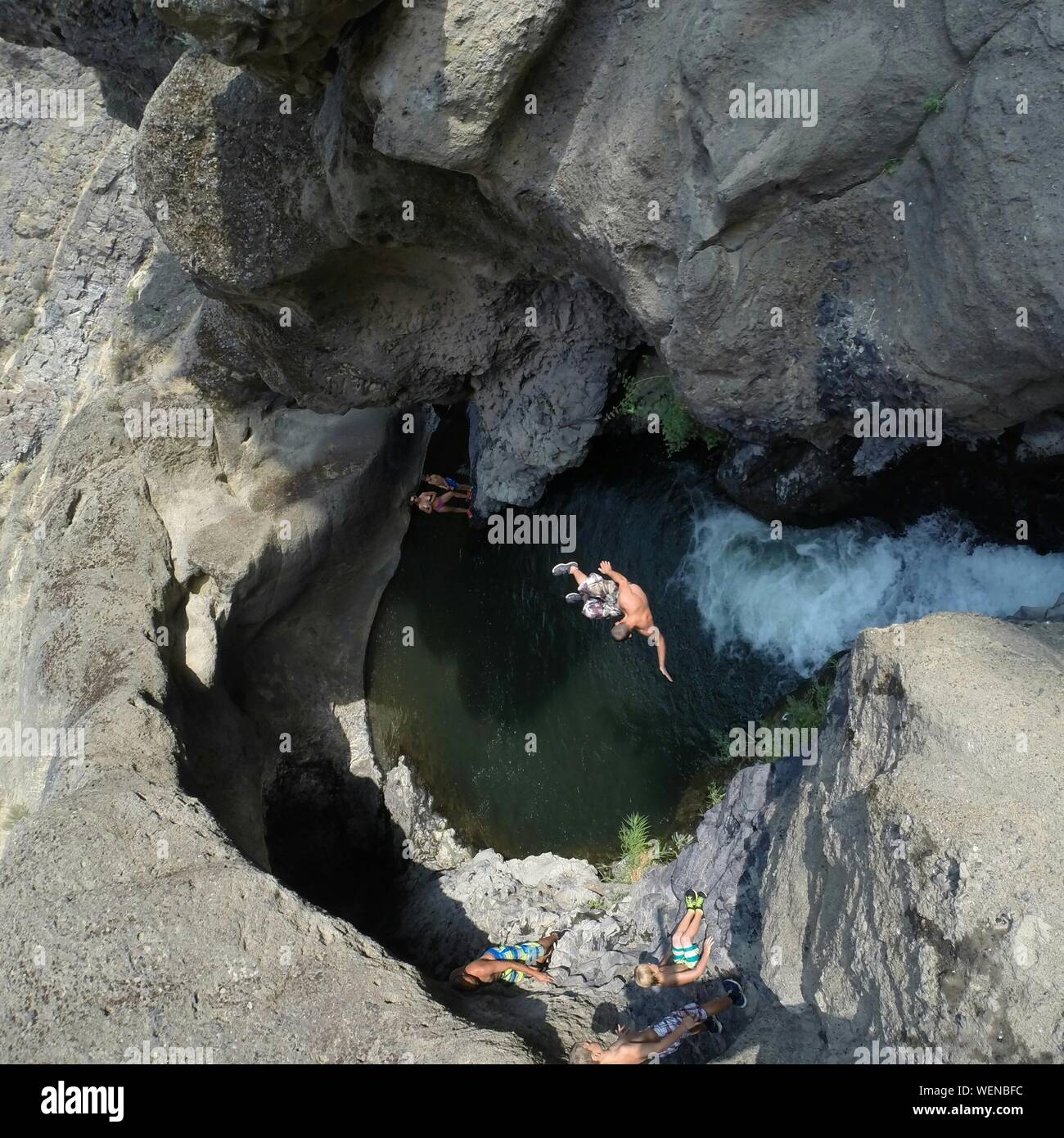 Jumping from rock into water hi-res stock photography and images - Alamy