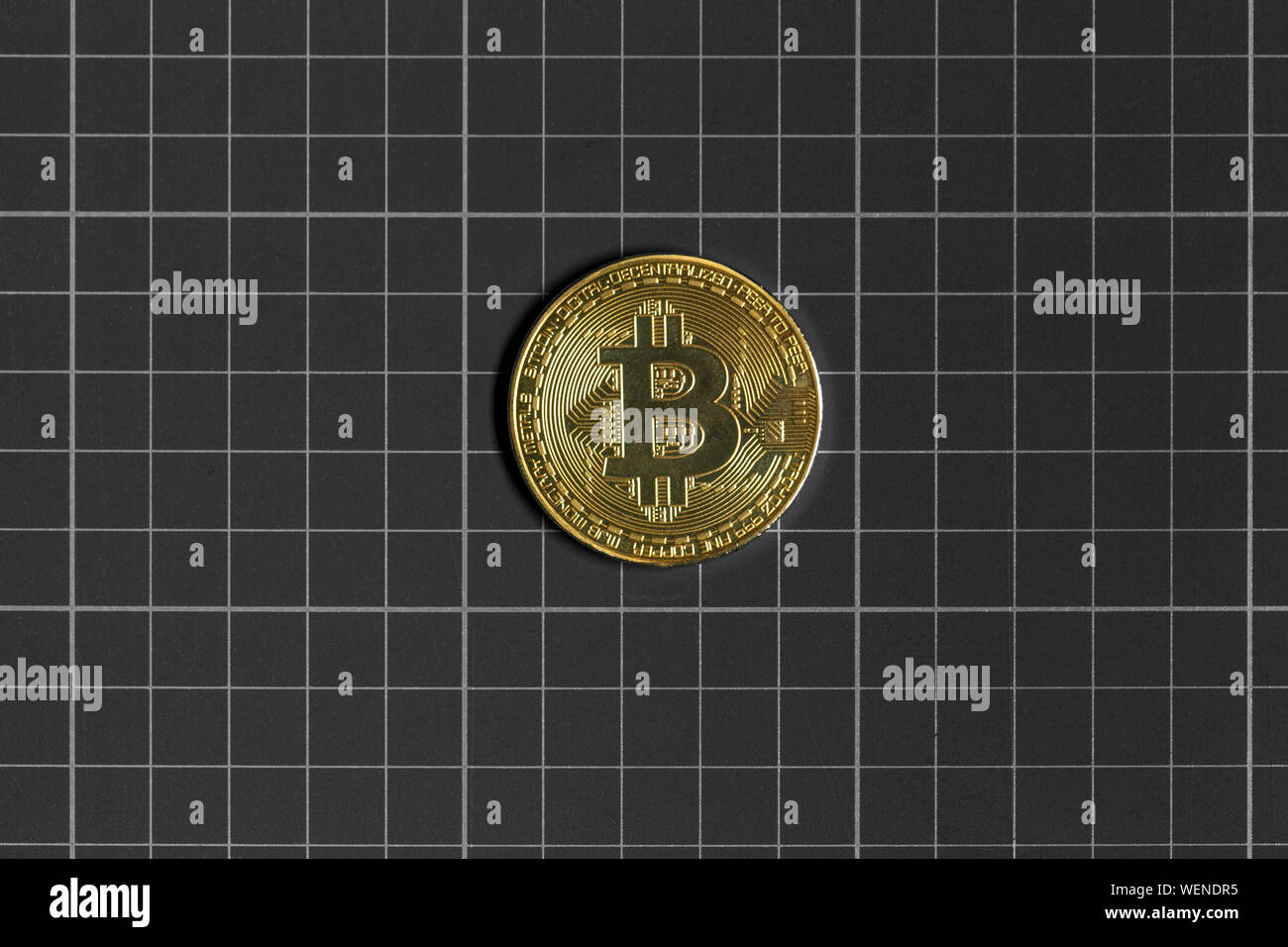 Physical bitcoin on top of a black and white grid board Stock Photo - Alamy