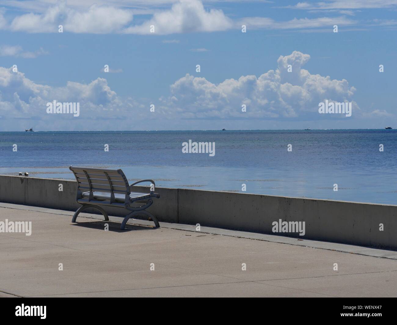 Medium wide shot of a bench facing the ocean along S Roosevelt ...