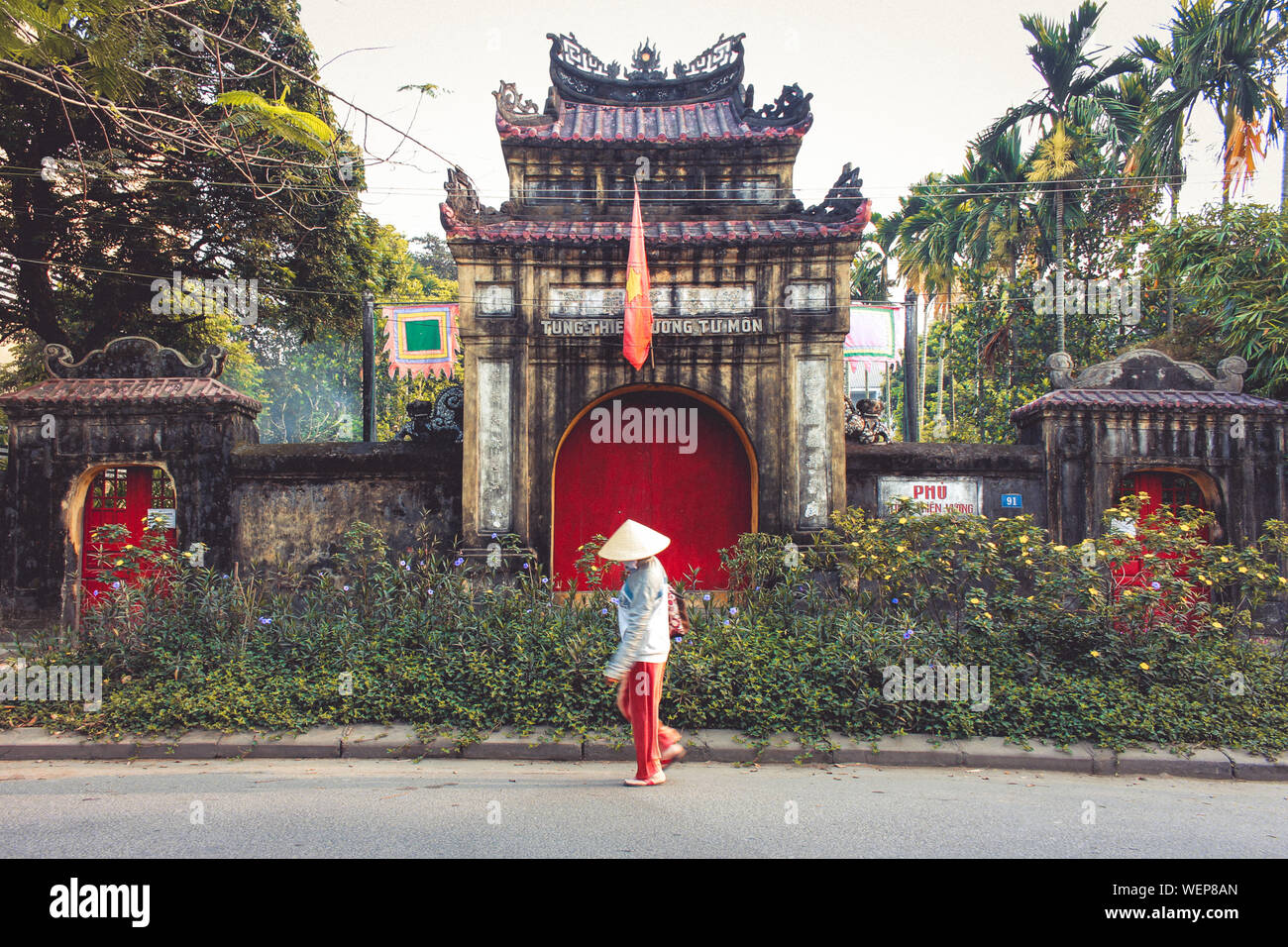 Person In Asian Style Conical Hat Against Traditional Building Stock ...