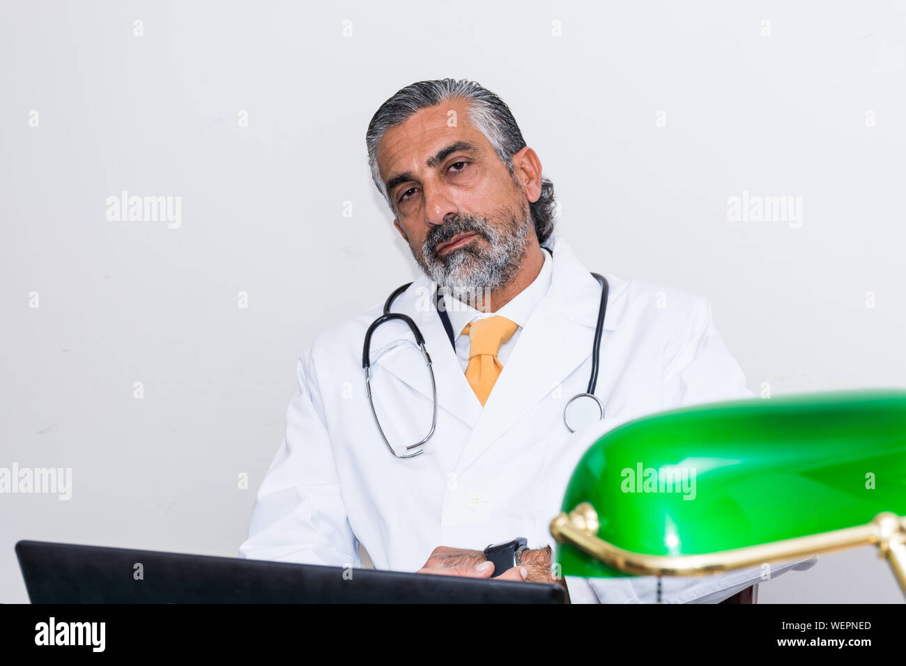 Doctor sitting on chair hi-res stock photography and images - Alamy