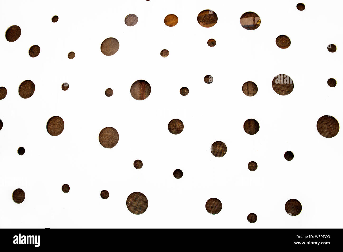 multiple circular holes on a white background Stock Photo - Alamy