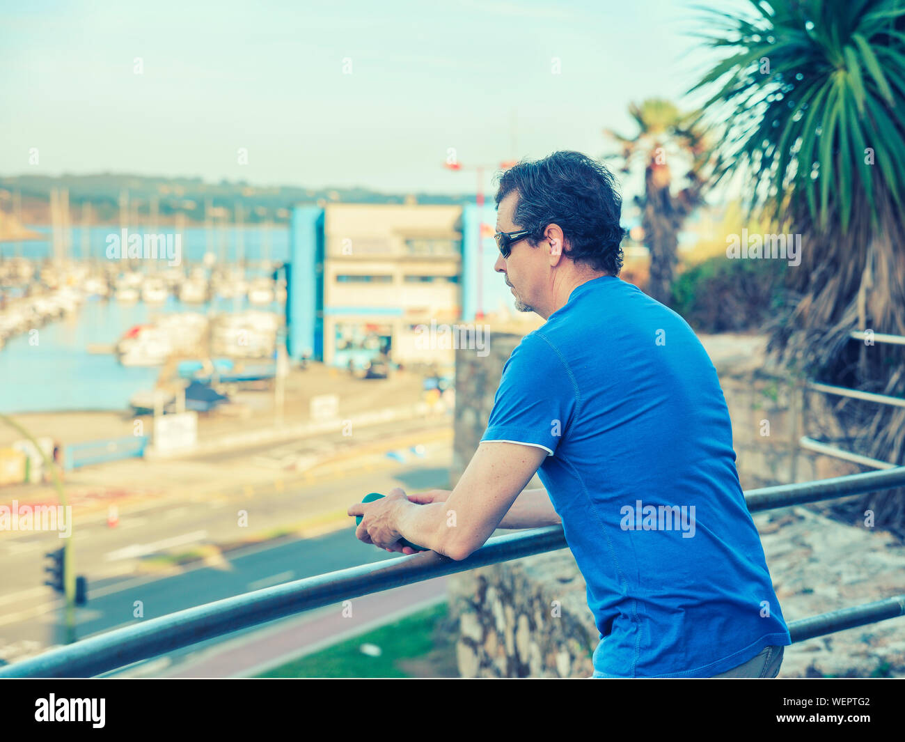 man leaning on a railing and thinking in the future leaning on a ...