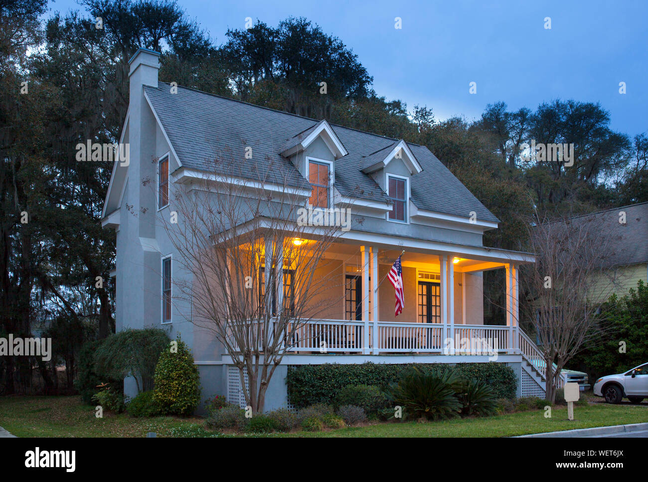 Two story house lit up at twilight Stock Photo - Alamy