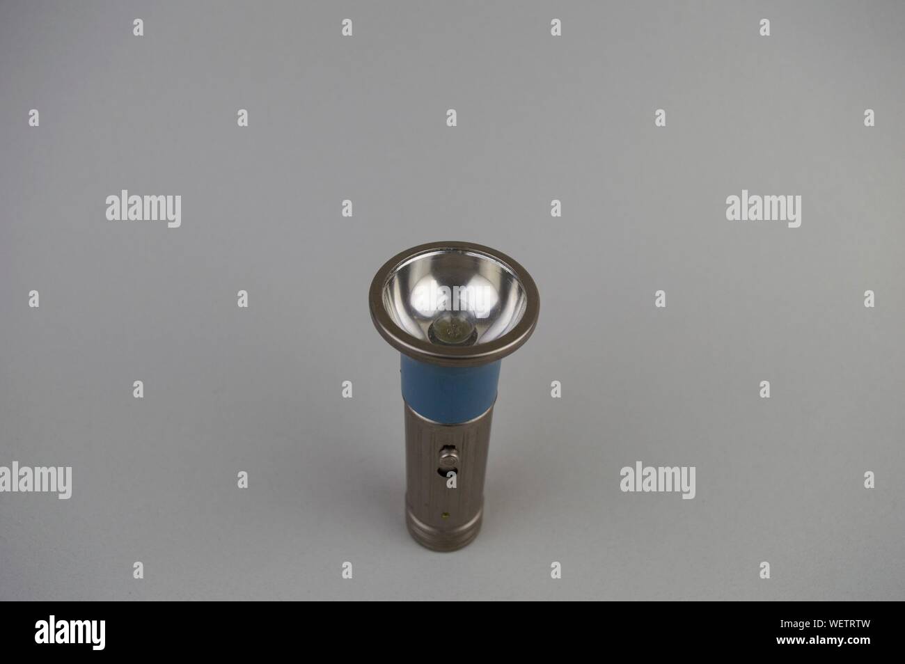 Pocket old flashlight on a gray background with a place to fill text ...