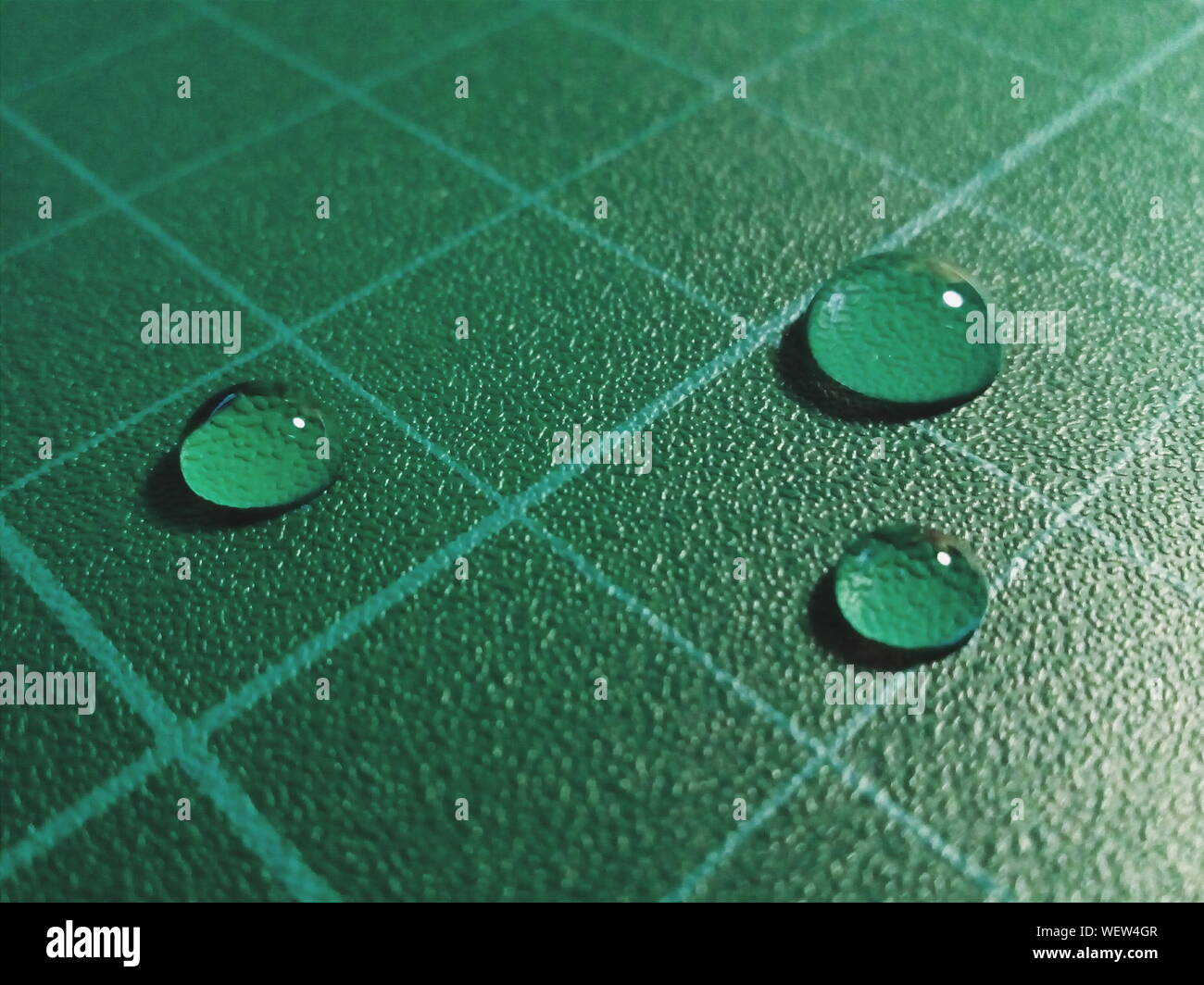 Water Drops On Green Cutting Mat Stock Photo - Alamy