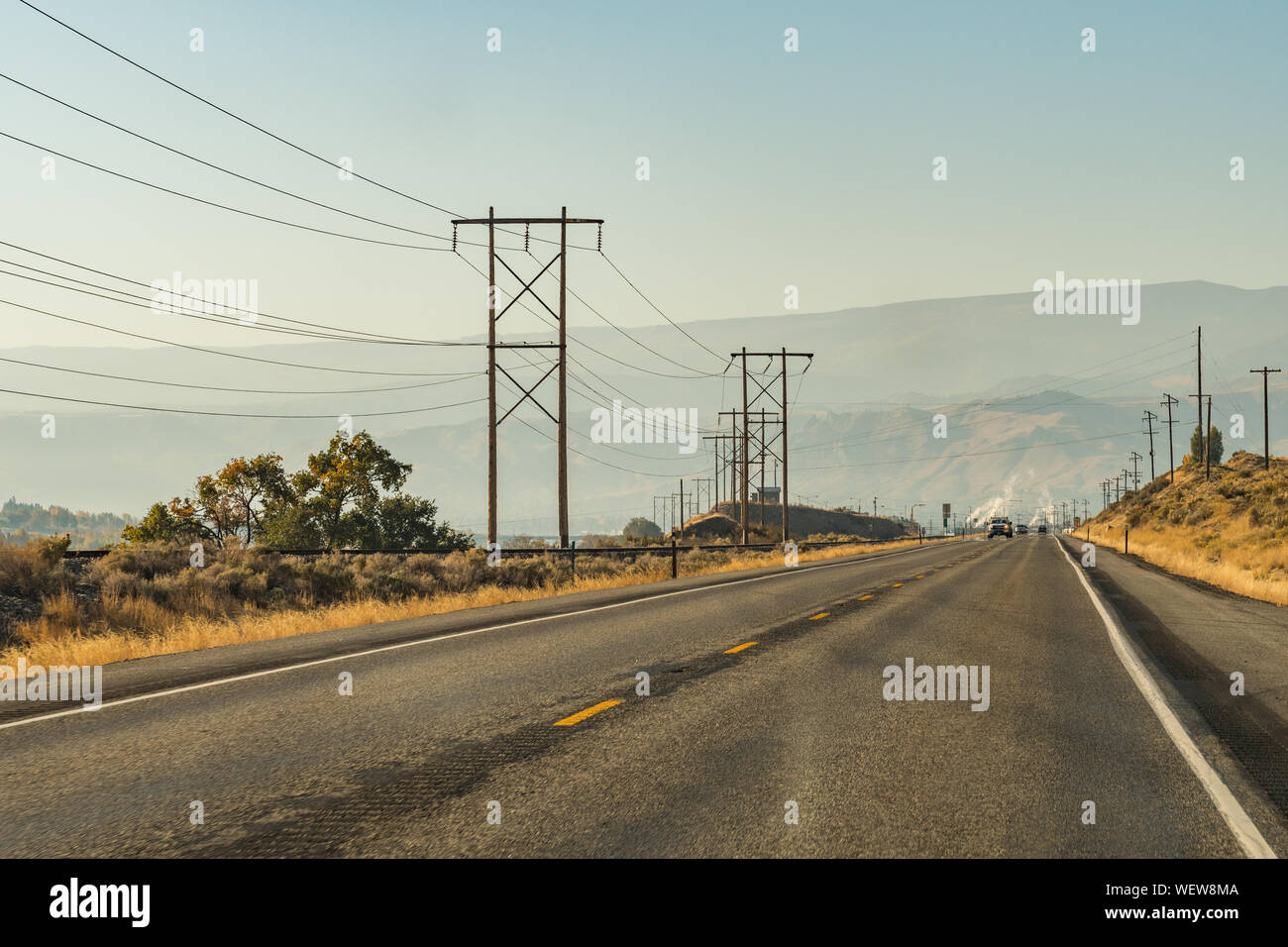Road and smoke from chimneys in the background on Highway 2 in ...