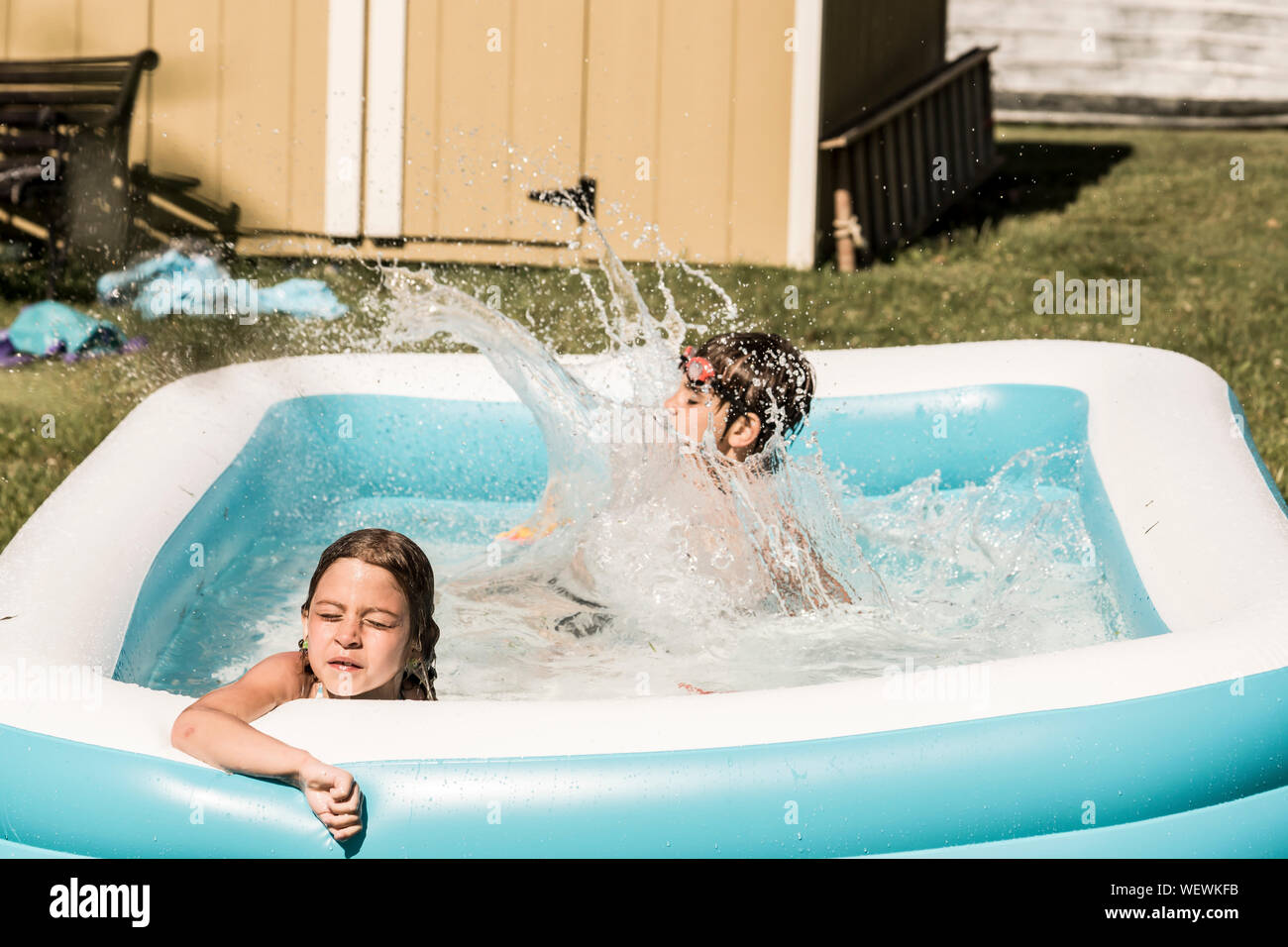 Brother sister playing in pool hi-res stock photography and images - Alamy