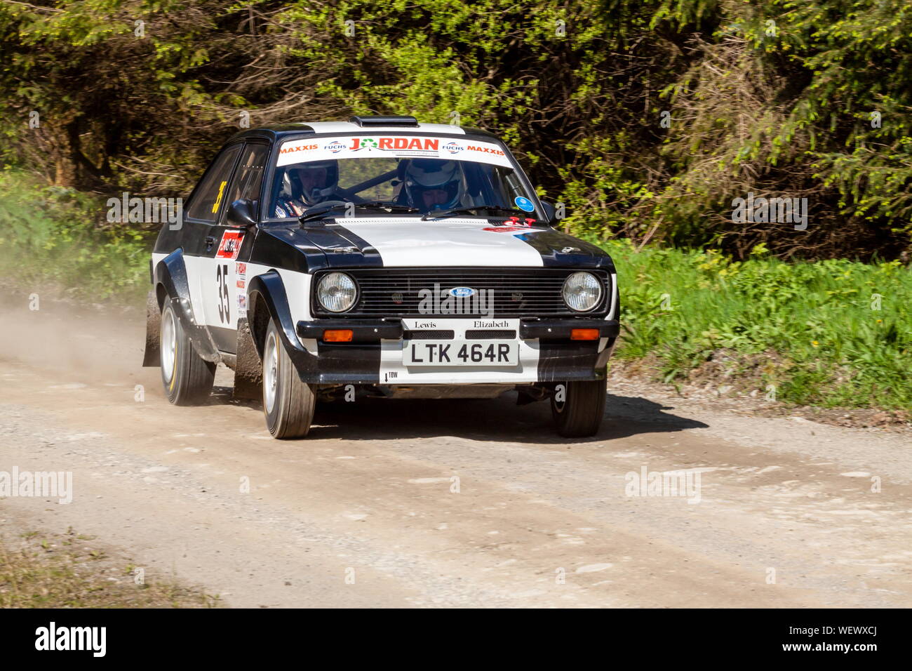 A Ford Mkii Escort rally car races through Dyfnant forest on the Plains ...