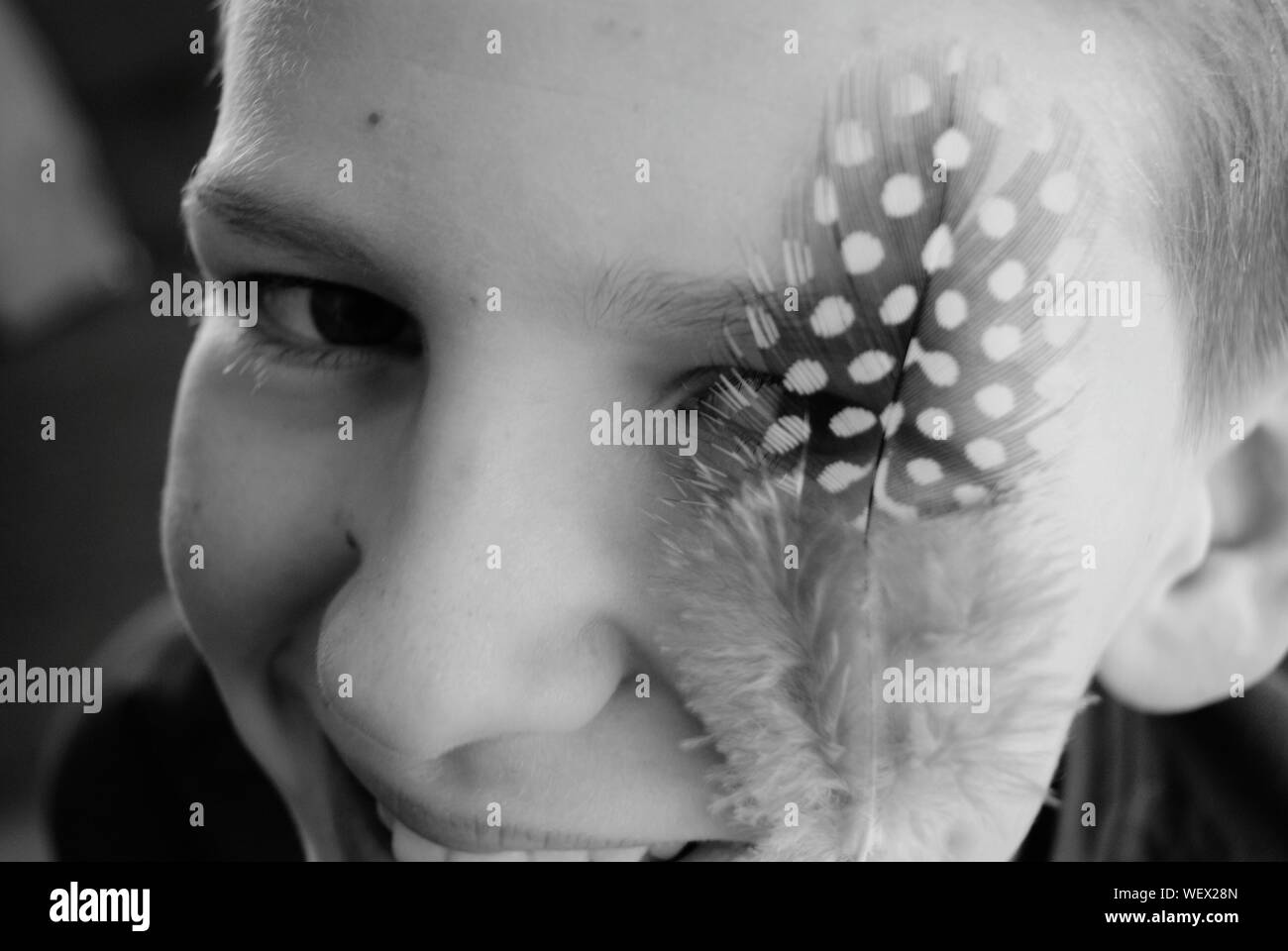Child holding feather hi-res stock photography and images - Alamy