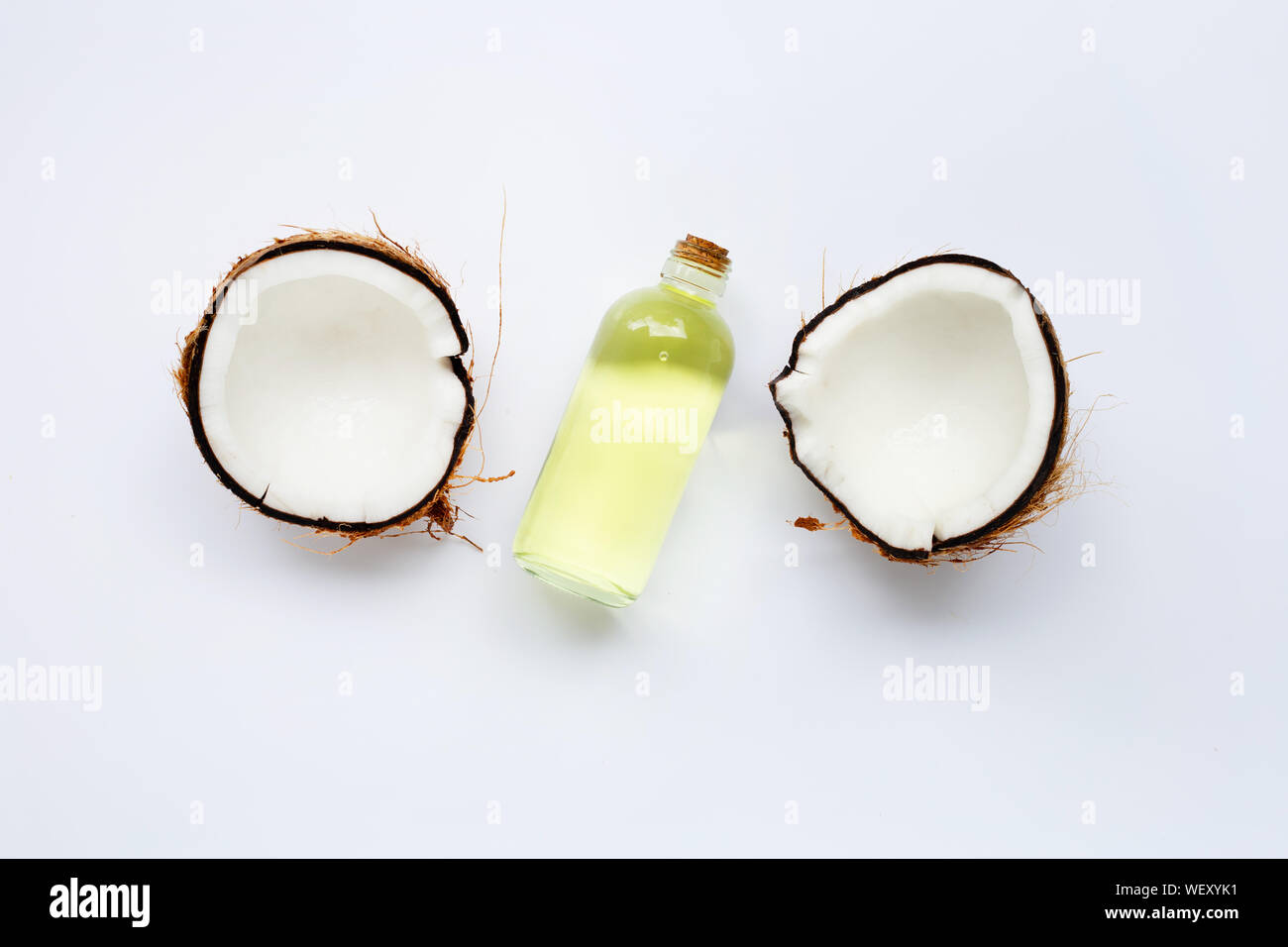 Coconut oil with coconuts on white background Stock Photo - Alamy