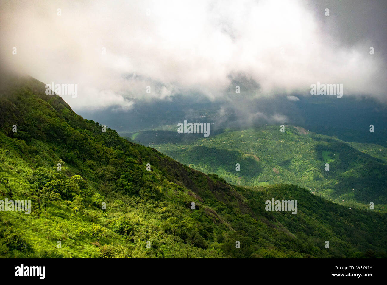 Great green mountain ranges. Peaks surrounded by green plants and a ...