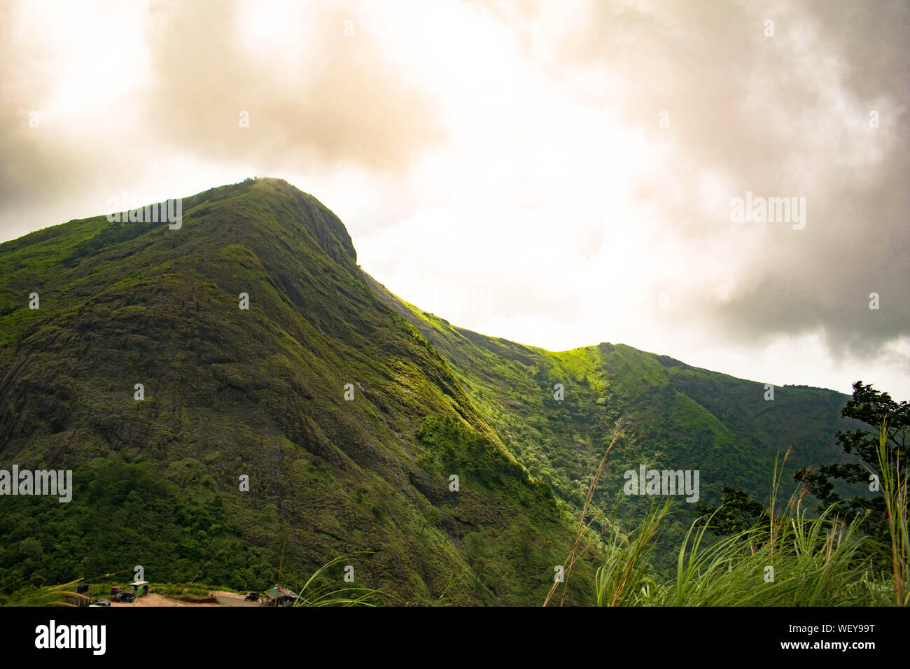 Great green mountain ranges. Peaks surrounded by green plants and a ...