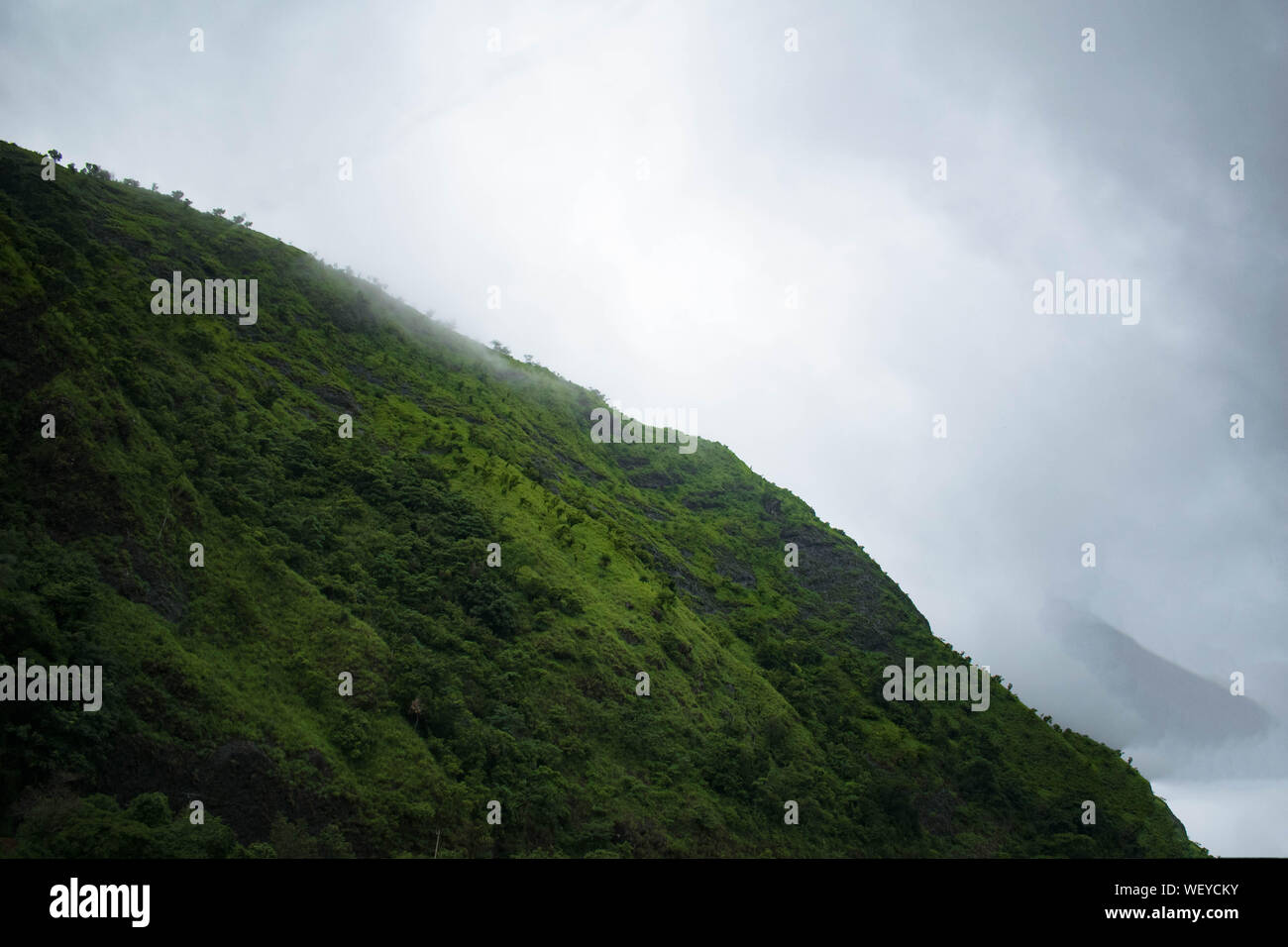 Great green mountain ranges. Peaks surrounded by green plants and a ...