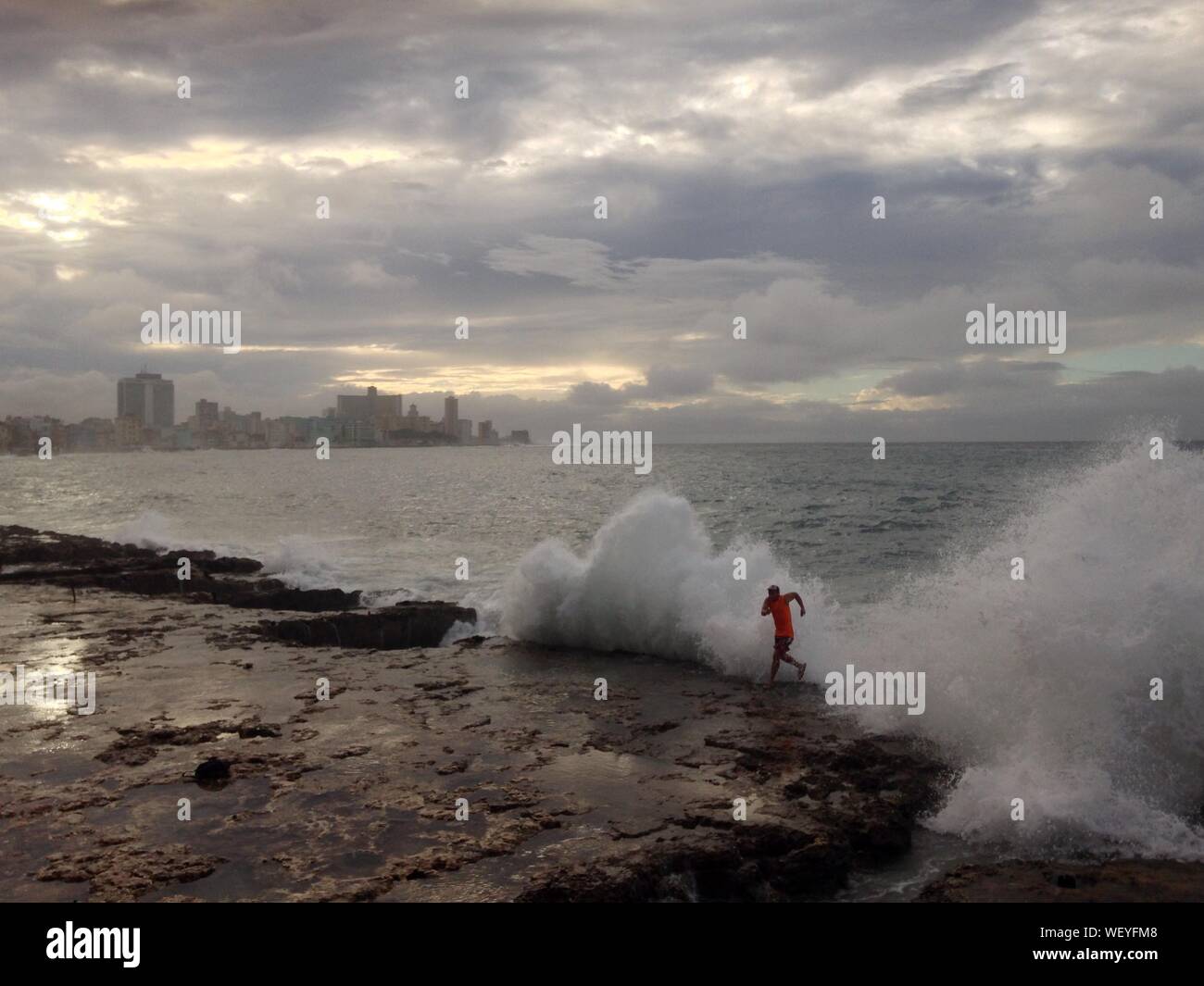 Man running in waves hi-res stock photography and images - Alamy