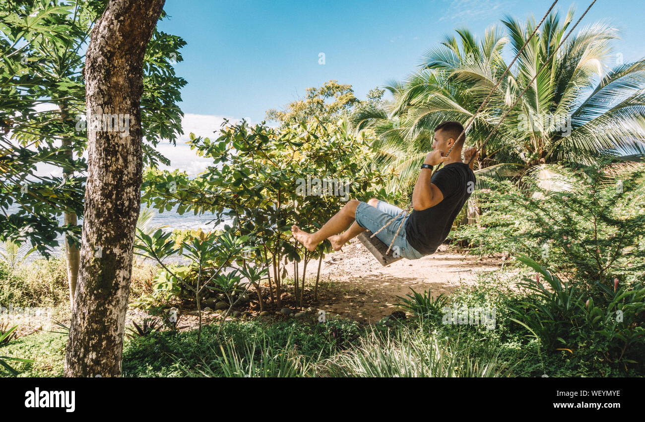 Man sitting on swing hi-res stock photography and images - Alamy