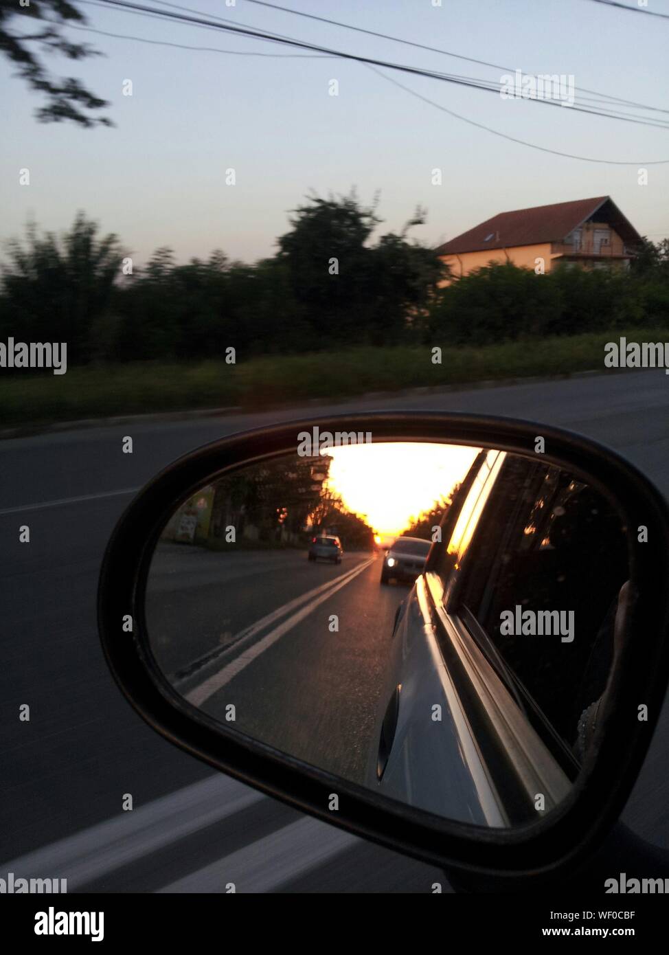 Reflection Of Cars On Side-view Mirror At Sunset Stock Photo - Alamy