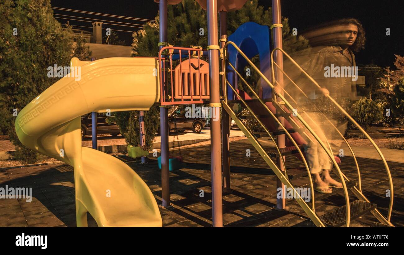 Playground slide man standing hi-res stock photography and images - Alamy