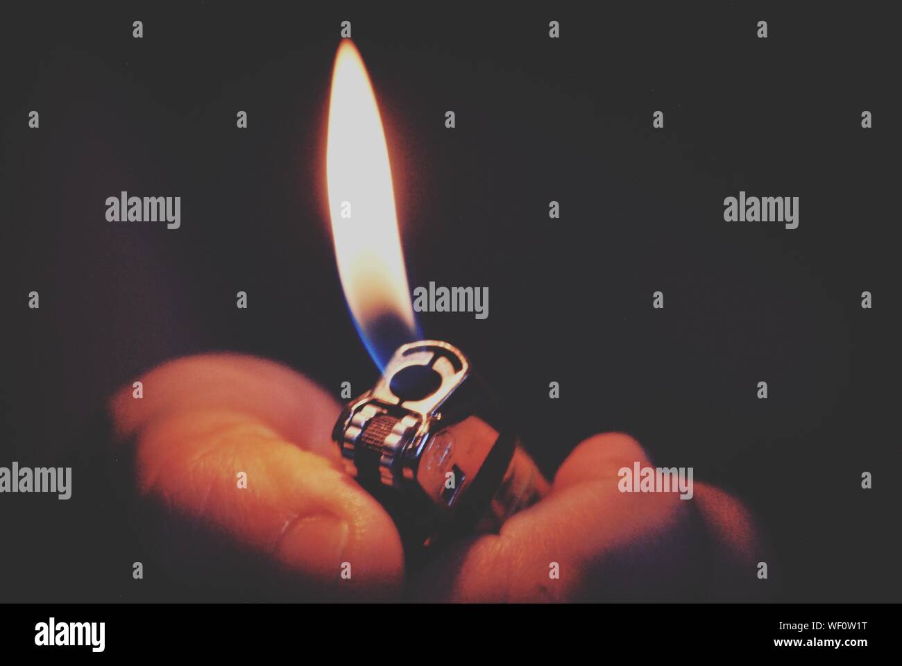 Hand holding lit lighter cigarette lighter hi-res stock photography and ...