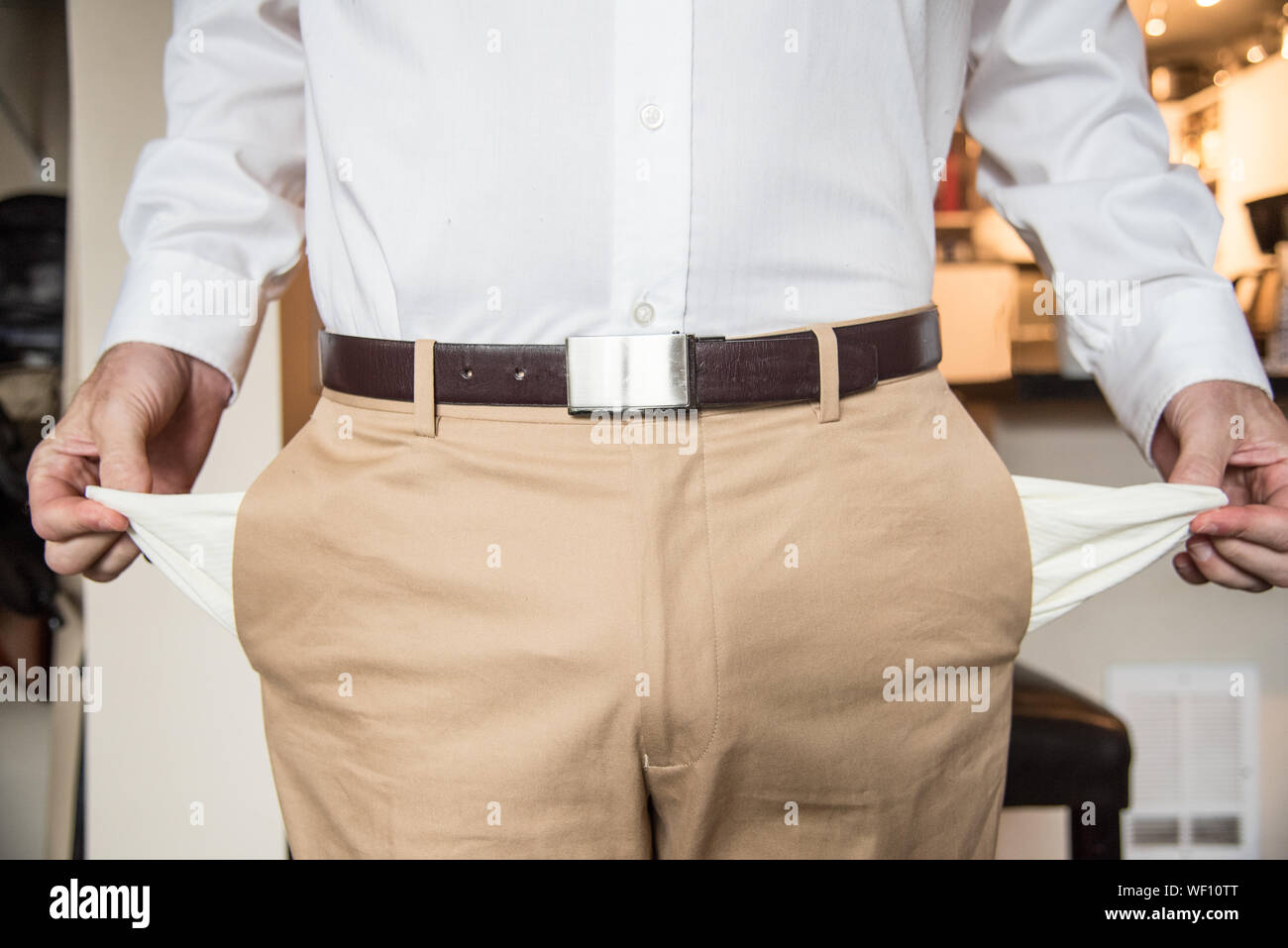 Man holding empty pocket hi-res stock photography and images - Alamy
