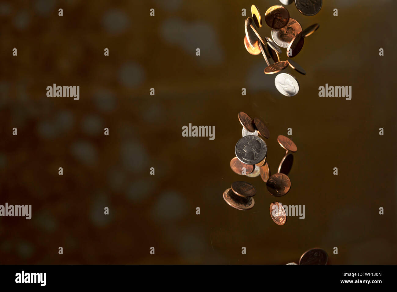 Falling American small metal coins Stock Photo - Alamy