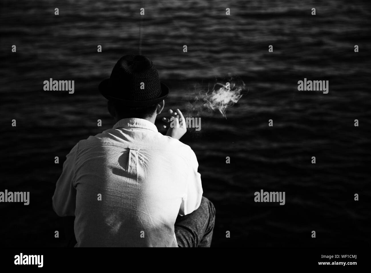 Man sitting outdoors rear view Black and White Stock Photos & Images ...