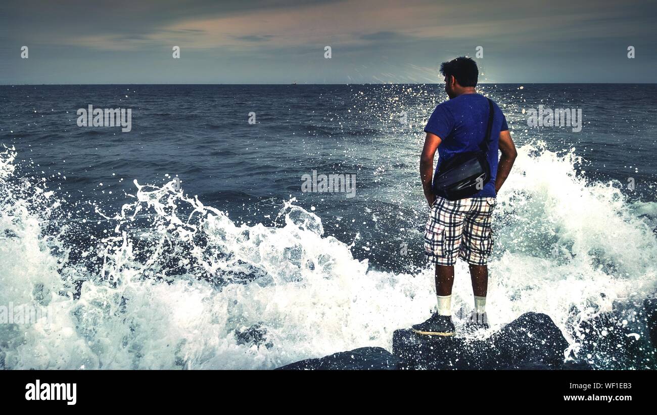 Waves man standing sea sunset hi-res stock photography and images - Alamy