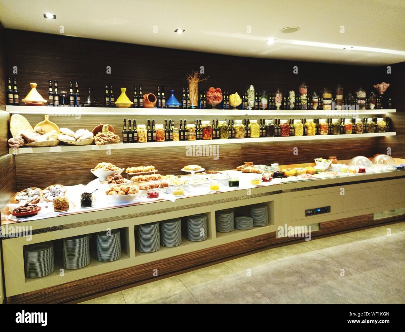 Luxurious Bar With Alcohol Bottles On Shelves And Food Stock Photo - Alamy