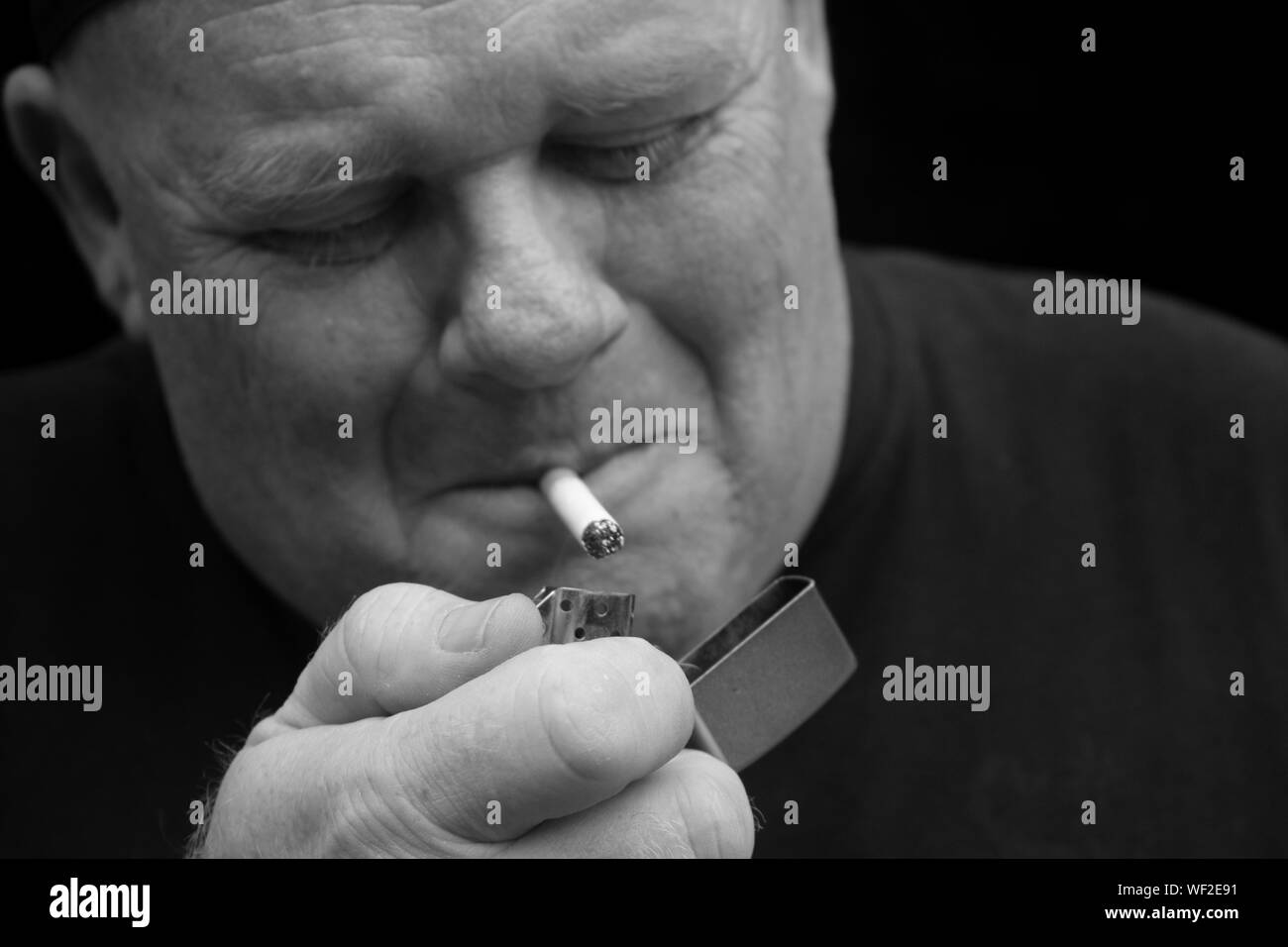 Man lighting up cigarette hi-res stock photography and images - Alamy
