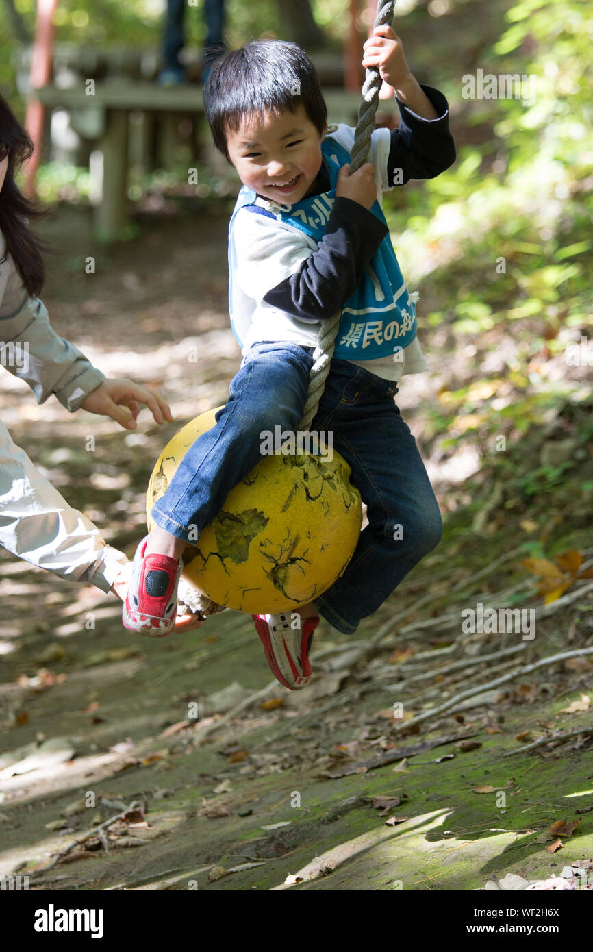 Child swinging on rope hi-res stock photography and images - Alamy