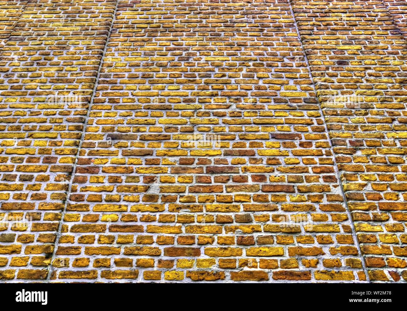Very detailed texture of yellow brick walls on aged and weathered ...